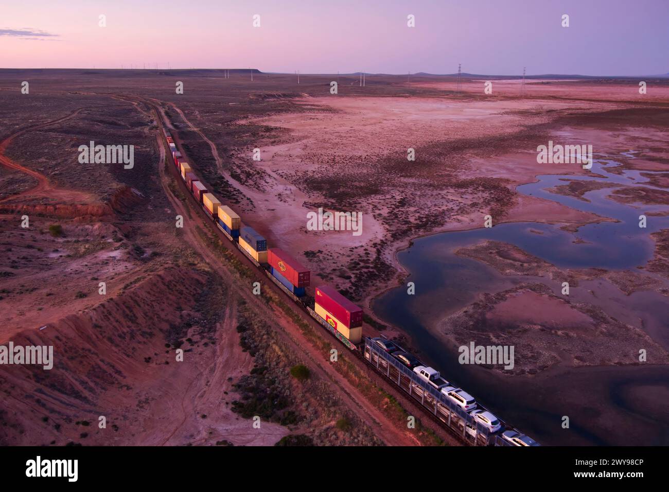 Aerial view of a freight train with colorful containers traveling ...