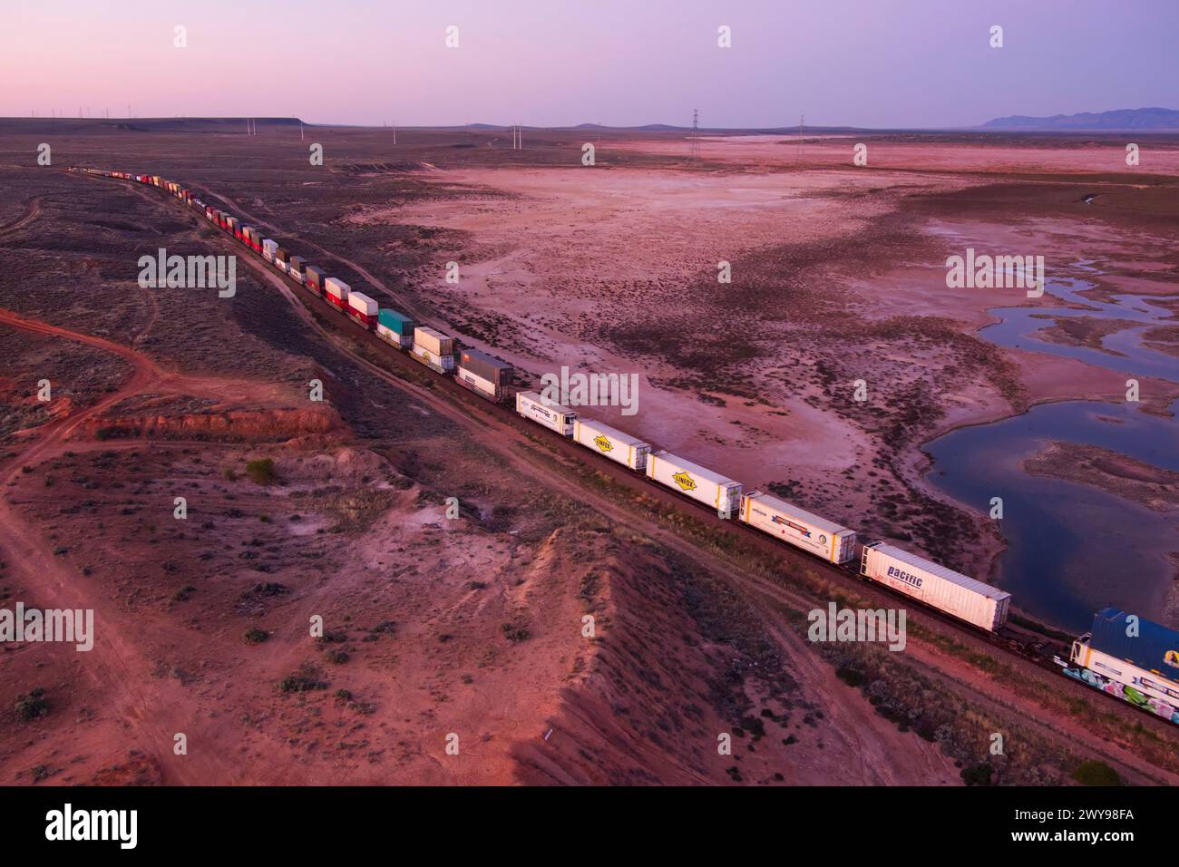 Aerial view of a freight train with colorful containers traveling ...