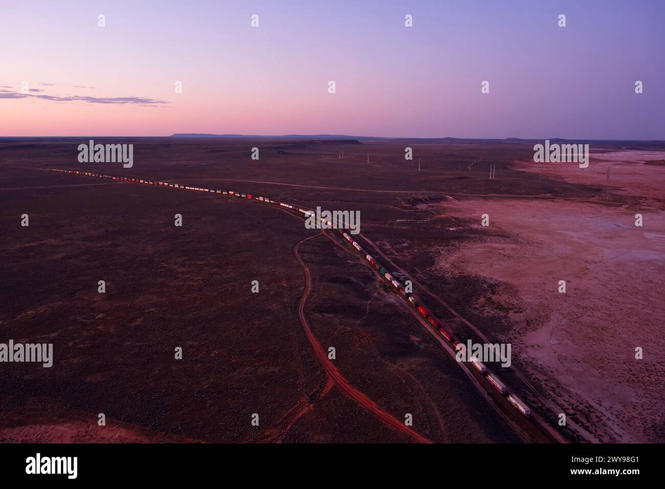 Aerial view of a freight train with colorful containers traveling ...