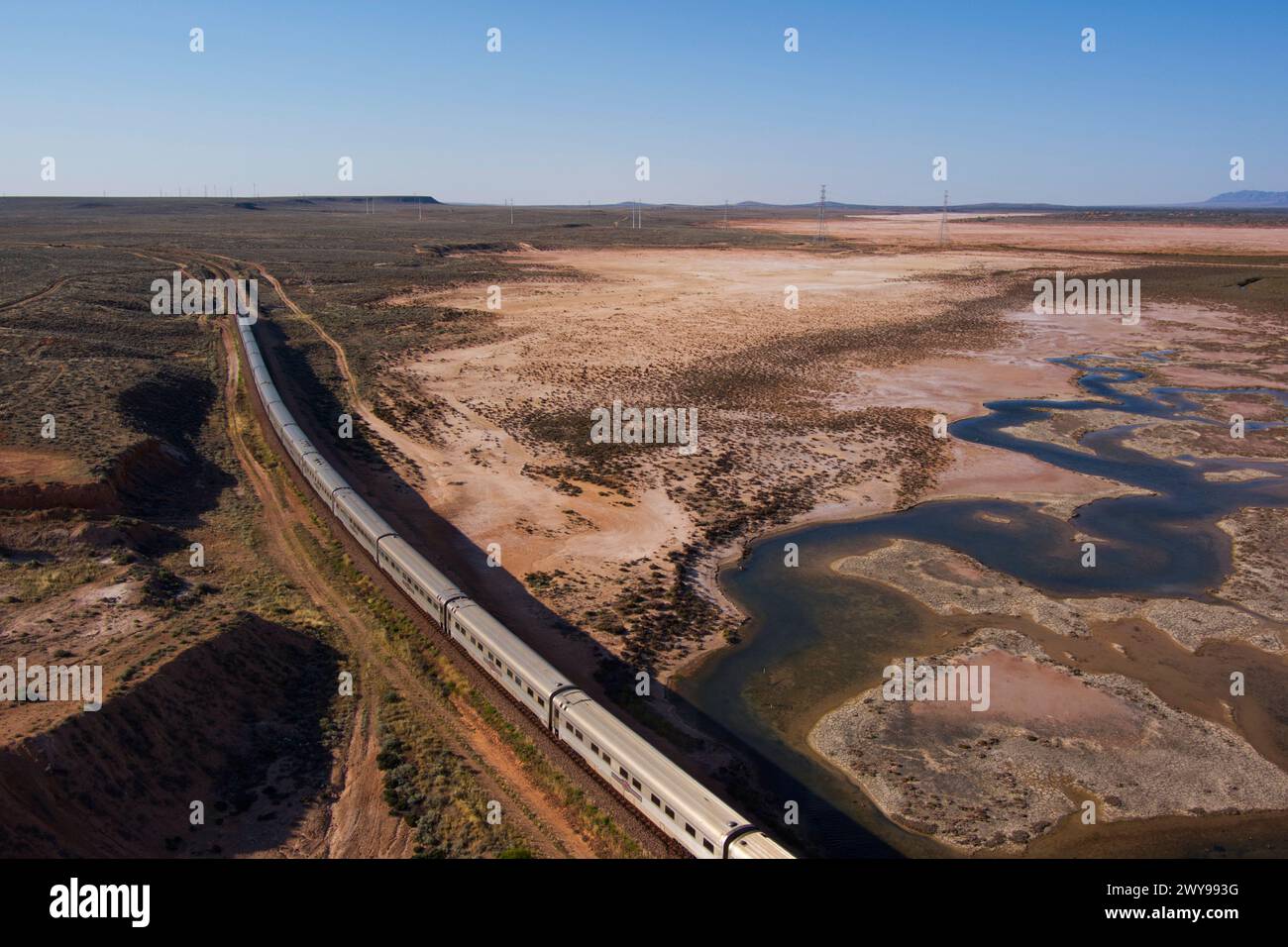 Aerial view of The Ghan a long passenger train traveling through a vast ...