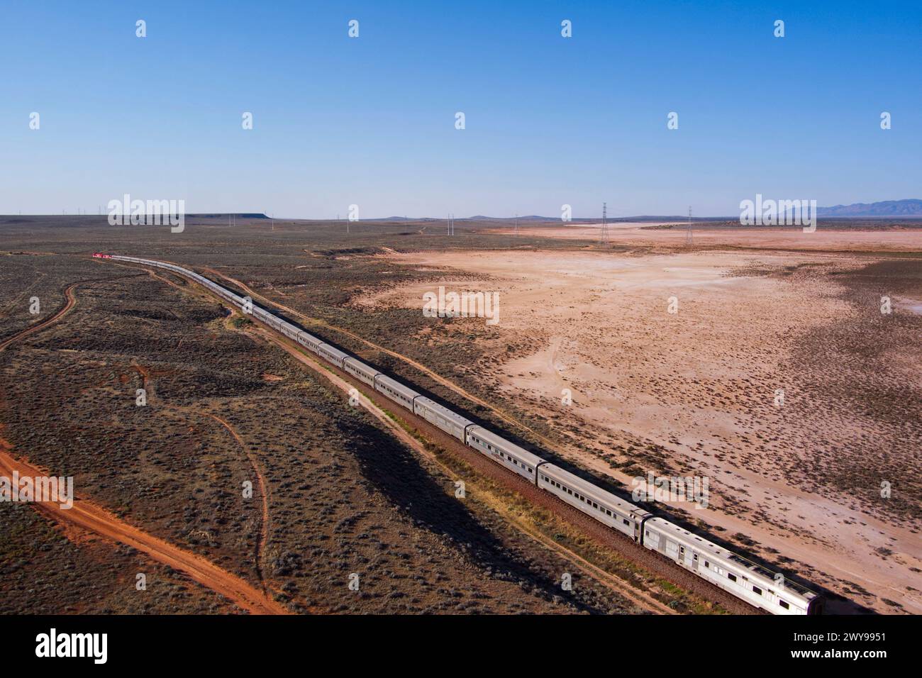 Aerial view of The Ghan a long passenger train traveling through a vast ...