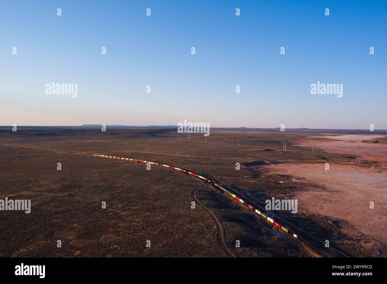 Aerial view of a intermodal container freight train traveling through a ...