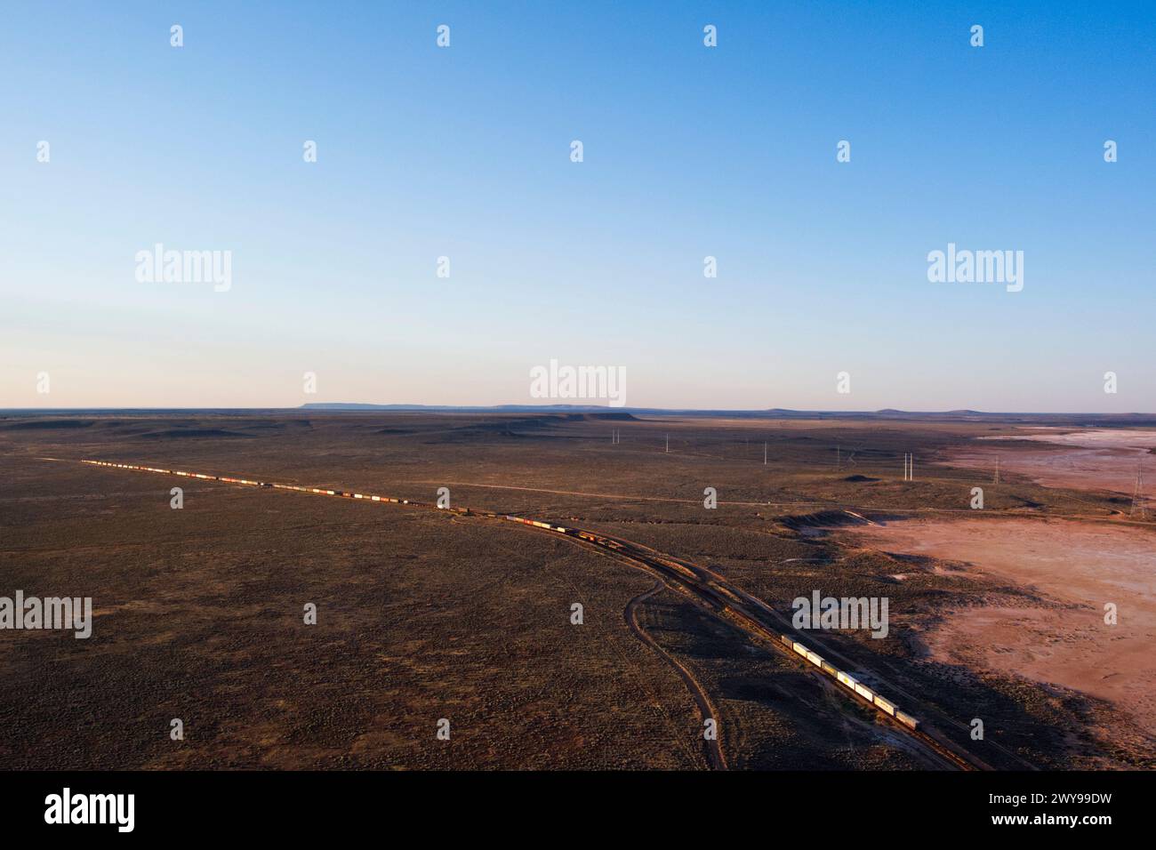 Aerial view of a intermodal container freight train traveling through a ...
