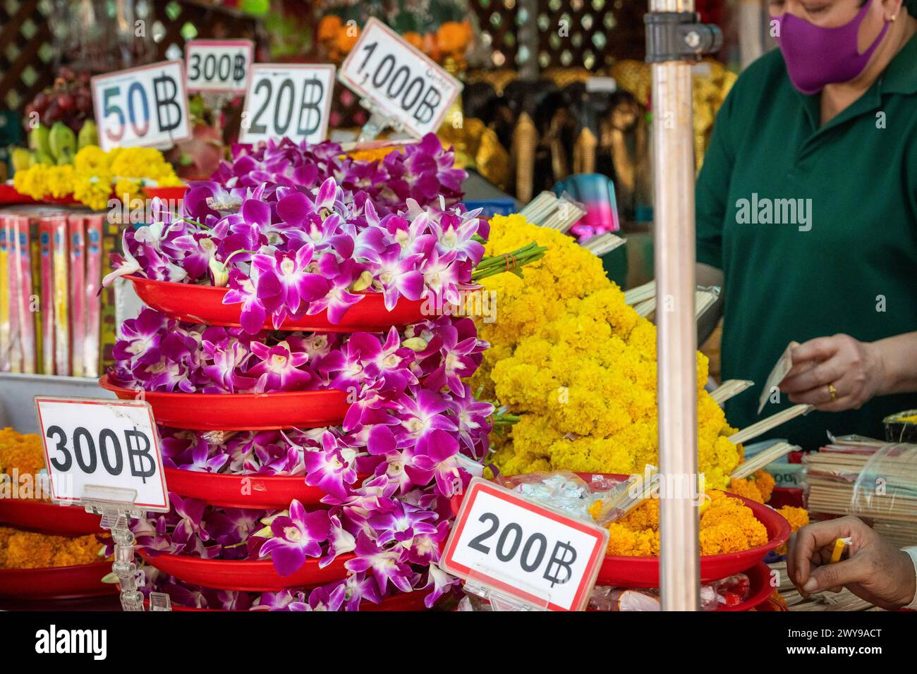 Display of flowers on sale for offerings and their respective prices ...