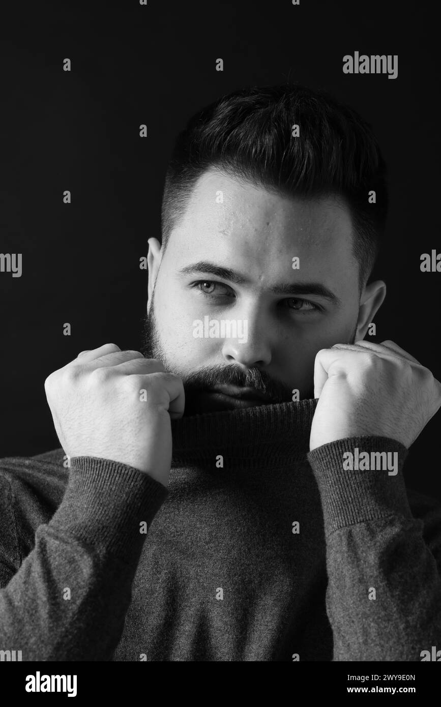 Portrait of handsome bearded man on dark background. Black and white ...
