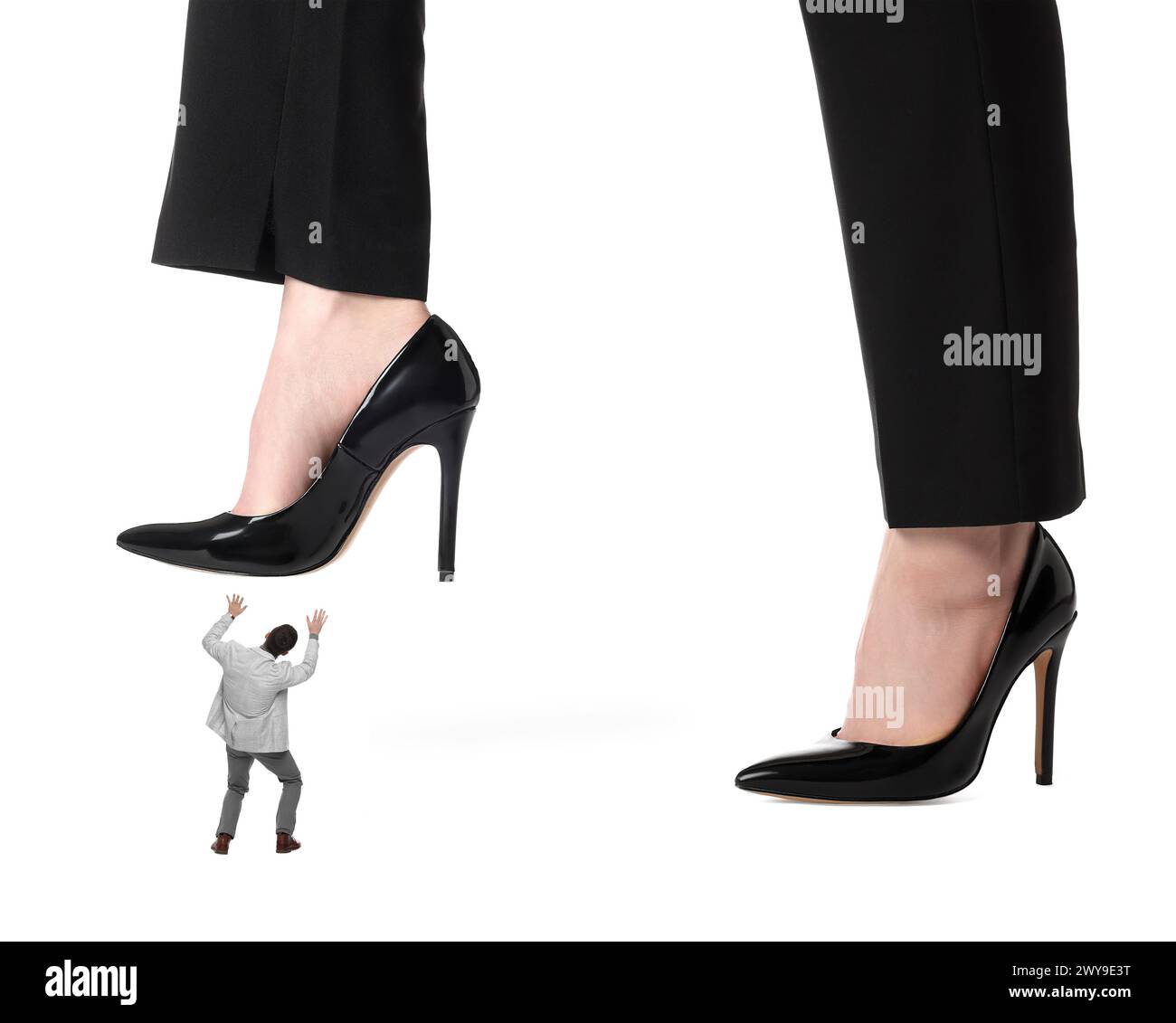 Big woman stepping onto small man on white background Stock Photo - Alamy