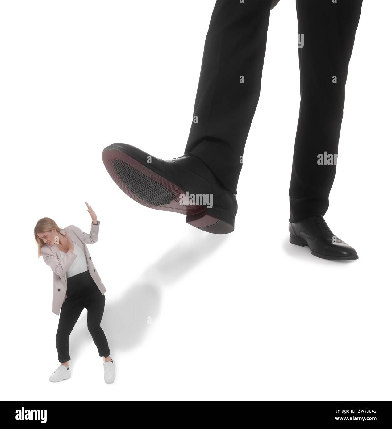 Big man stepping onto small woman on white background Stock Photo - Alamy