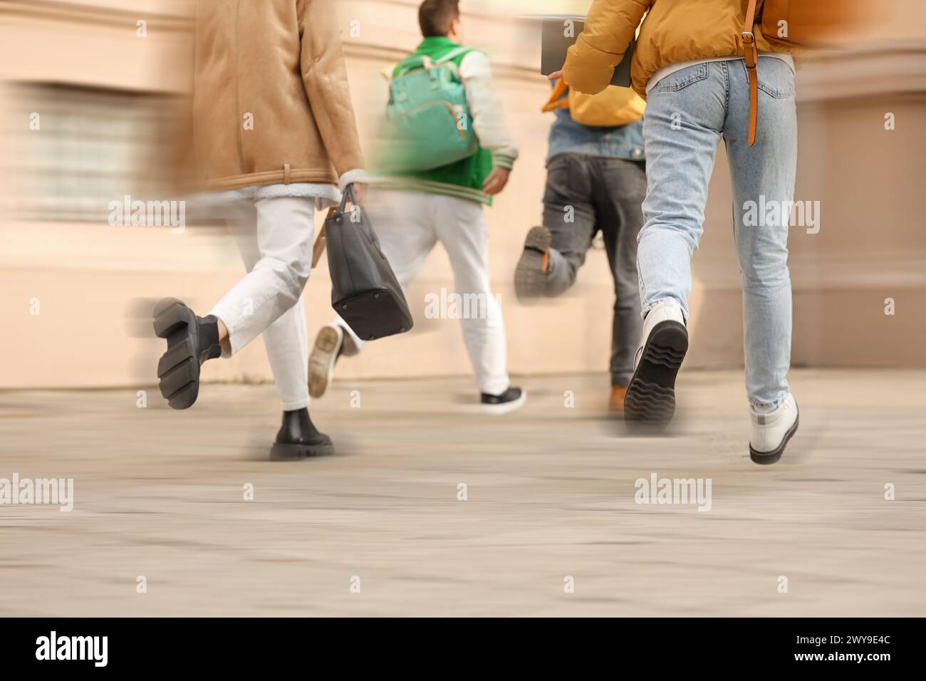 Being late. Group of students running for class. Motion blur effect ...