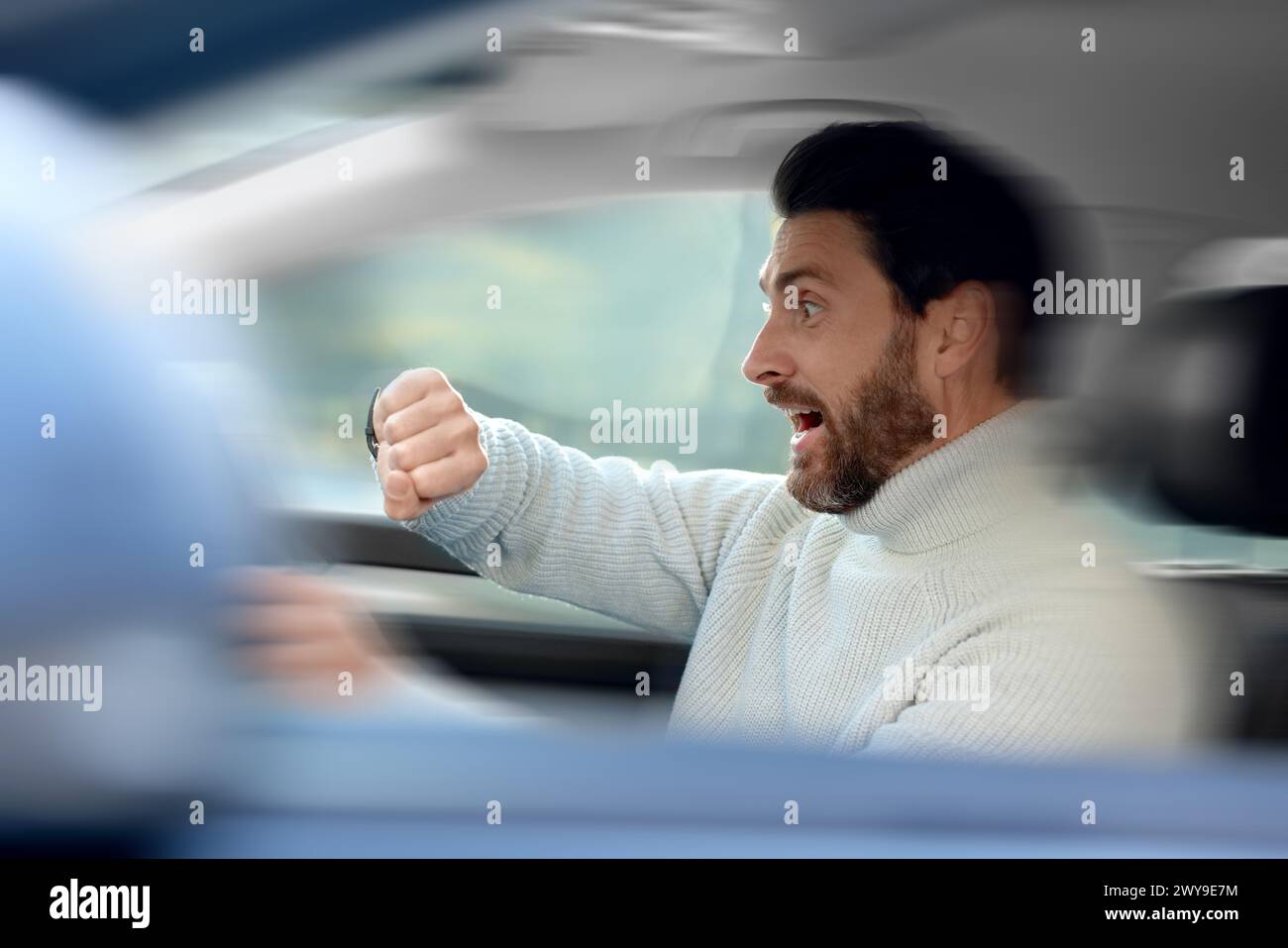 Being late. Stressed man checking time in car. Motion blur effect Stock Photo - Alamy