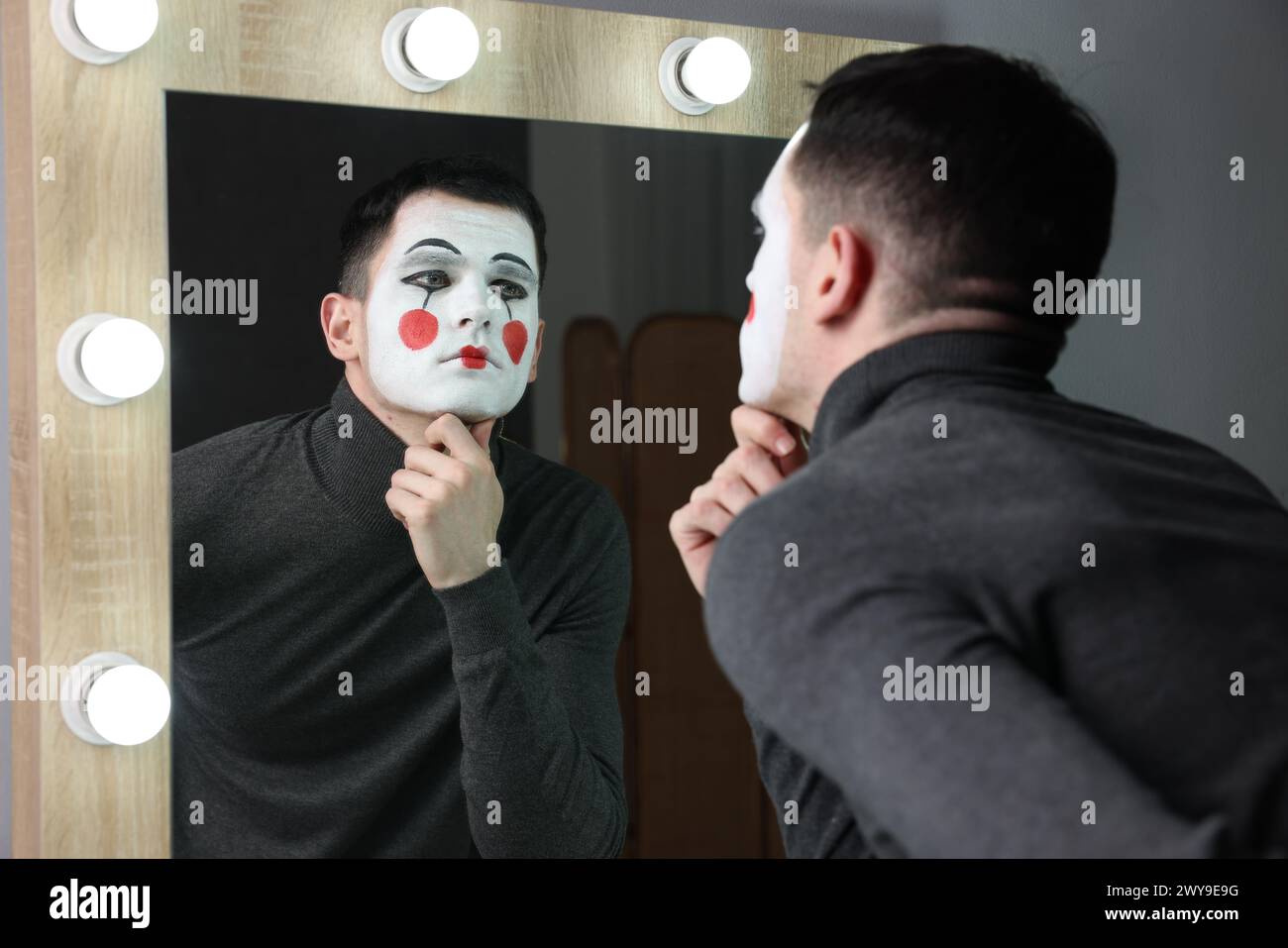 Mime artist posing near mirror in dressing room Stock Photo - Alamy