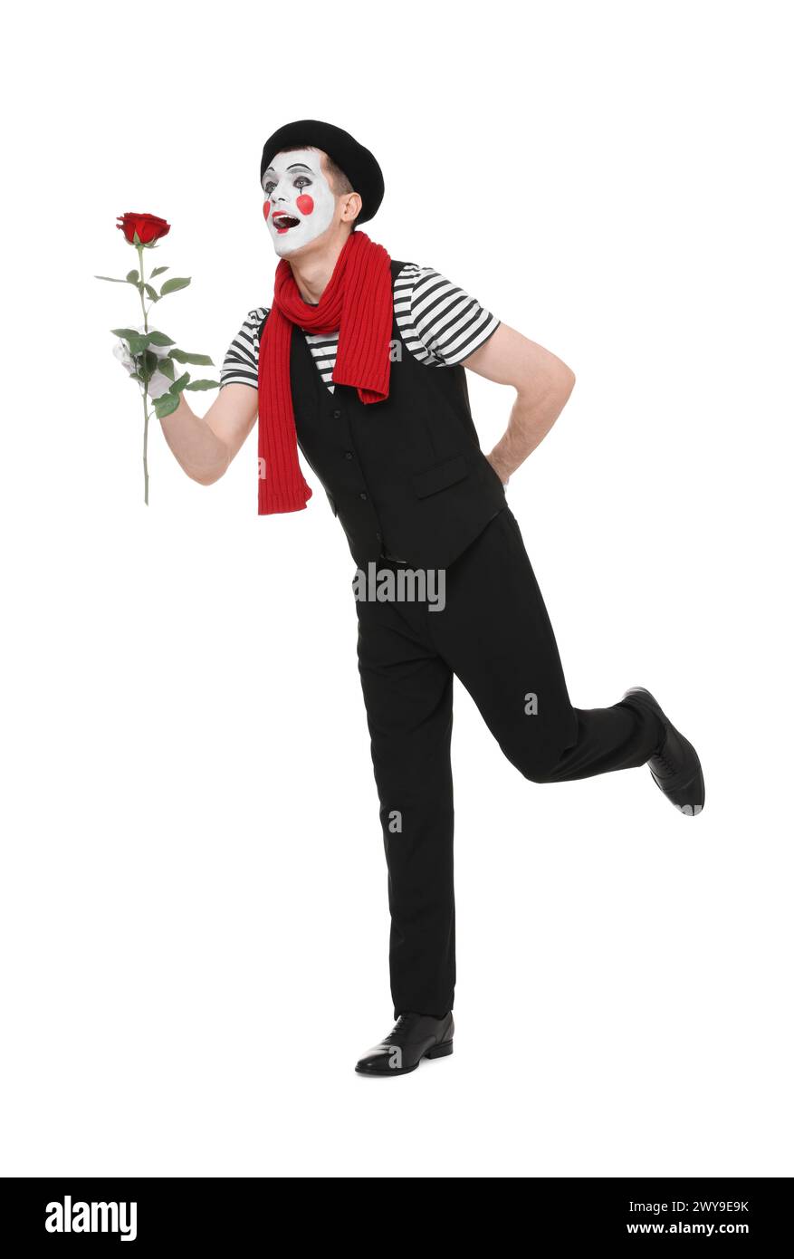 Funny mime artist with red rose posing on white background Stock Photo ...
