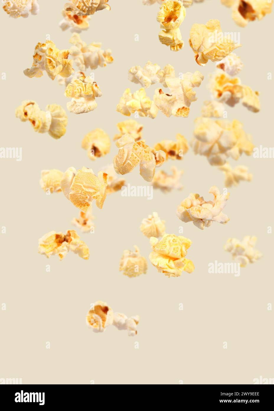 Tasty fresh popcorn flying on light grey background Stock Photo - Alamy