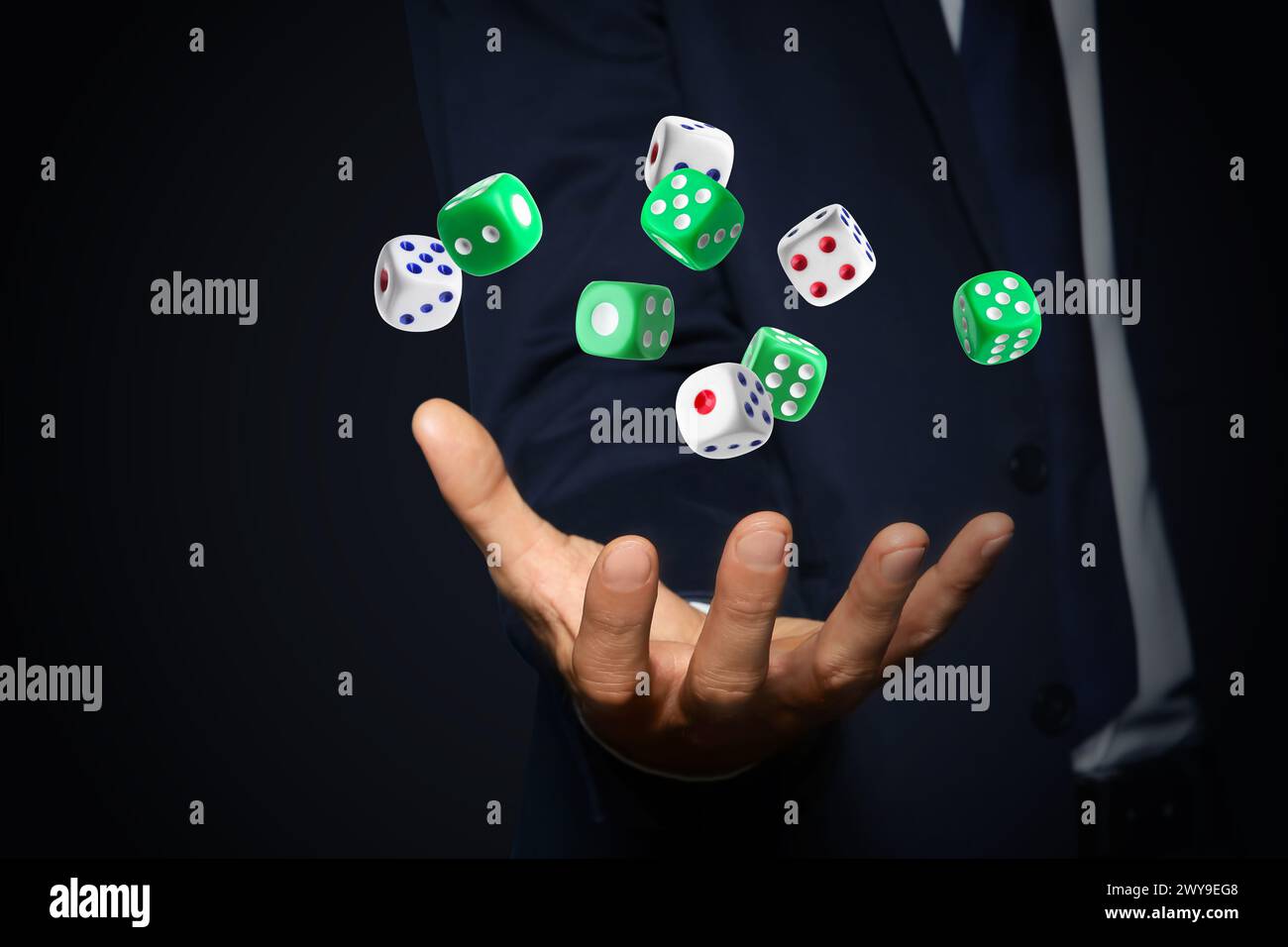 Businessman throwing dice on black background, closeup Stock Photo - Alamy