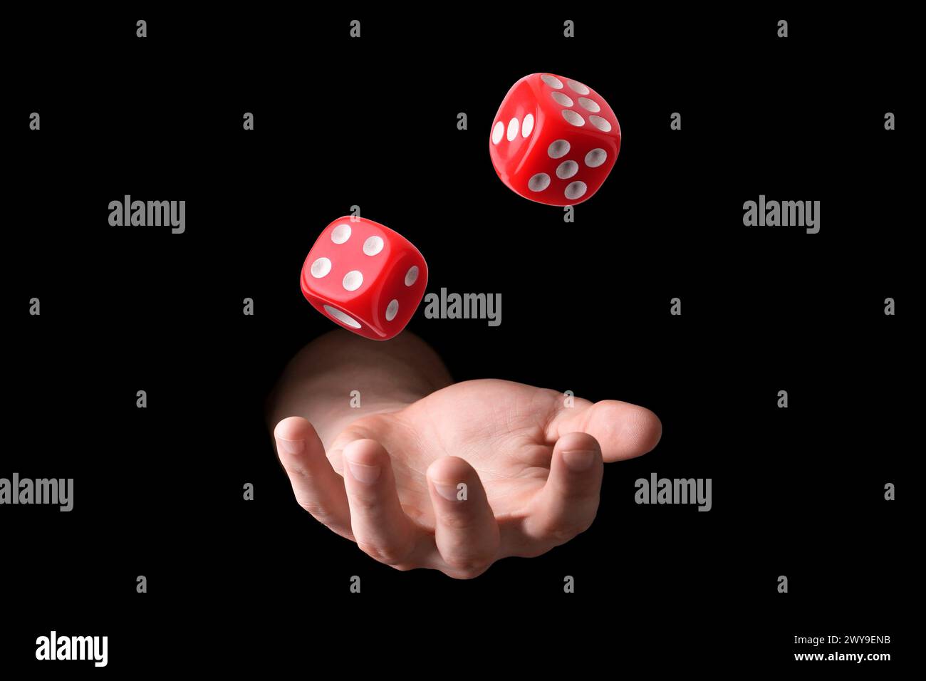 Man throwing red dice on black background, closeup Stock Photo - Alamy