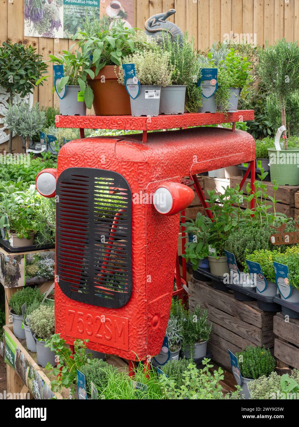 Old red tractor body used as a quirky display in Whilton Locks Garden ...