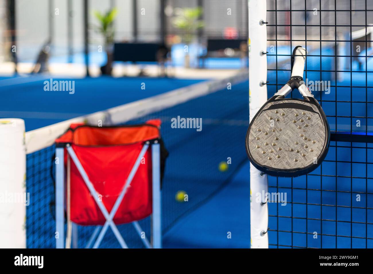 Paddle tennis: Padel racket and ball in front of an outdoor court Stock ...