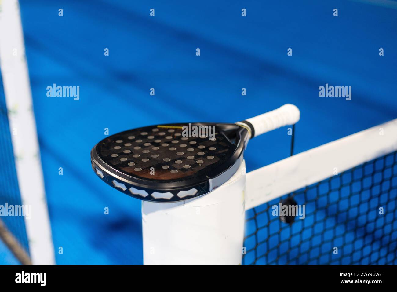 Paddle tennis: Paddel racket and ball in front of an outdoor court ...