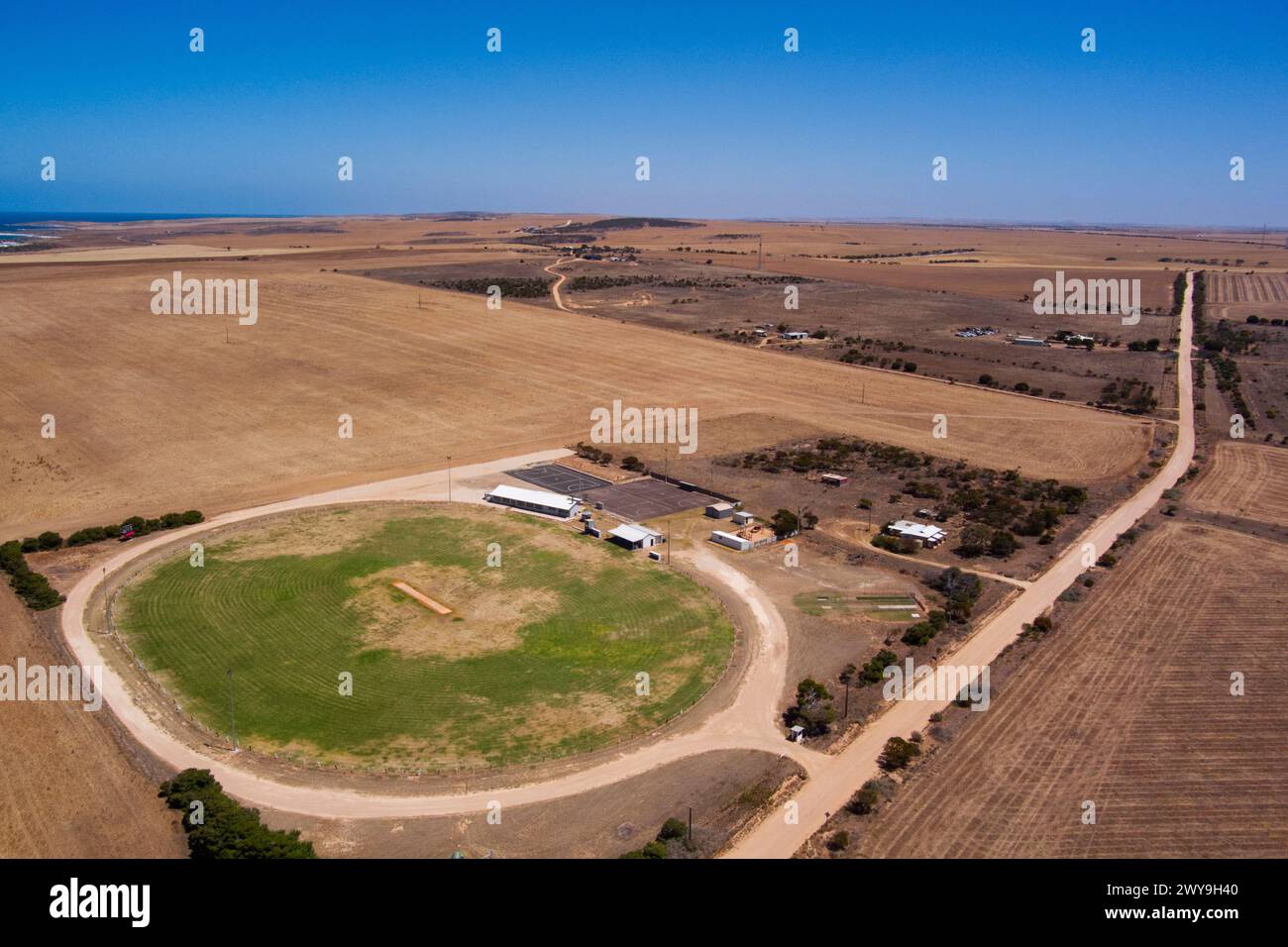 Aerial view of a rural landscape with circular green field, farm ...