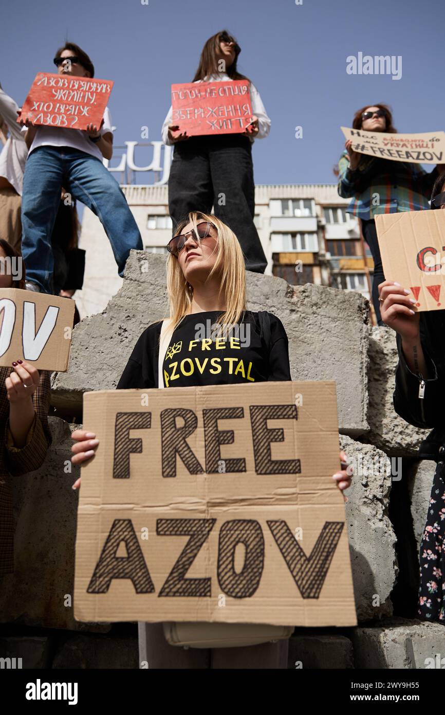 Ukrainian woman posing with banner "Free Azov" on a demonstration for release of captured ...