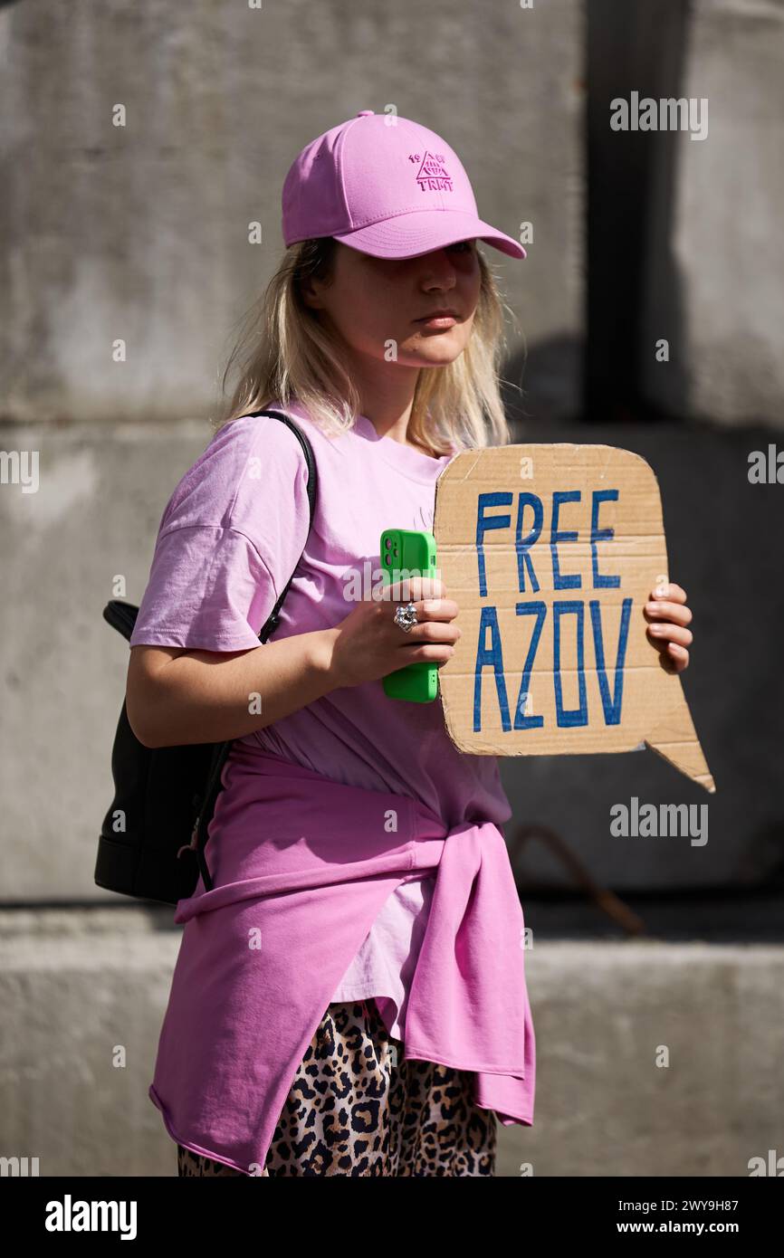 Ukrainian girl posing with a banner "Free Azov" on a public ...