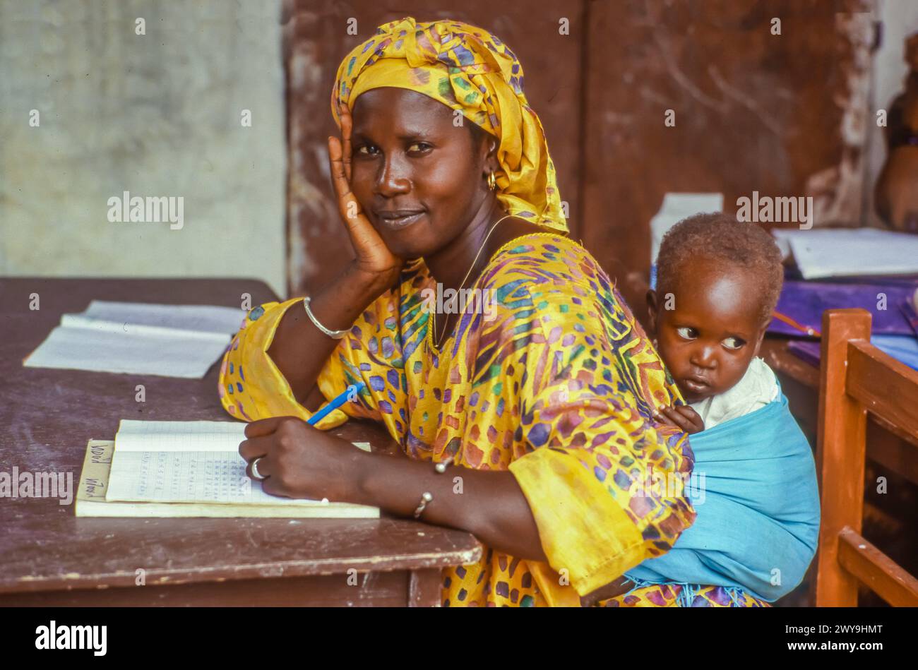 Senegal, Djogo, mother and child during a lesson of an adult education ...