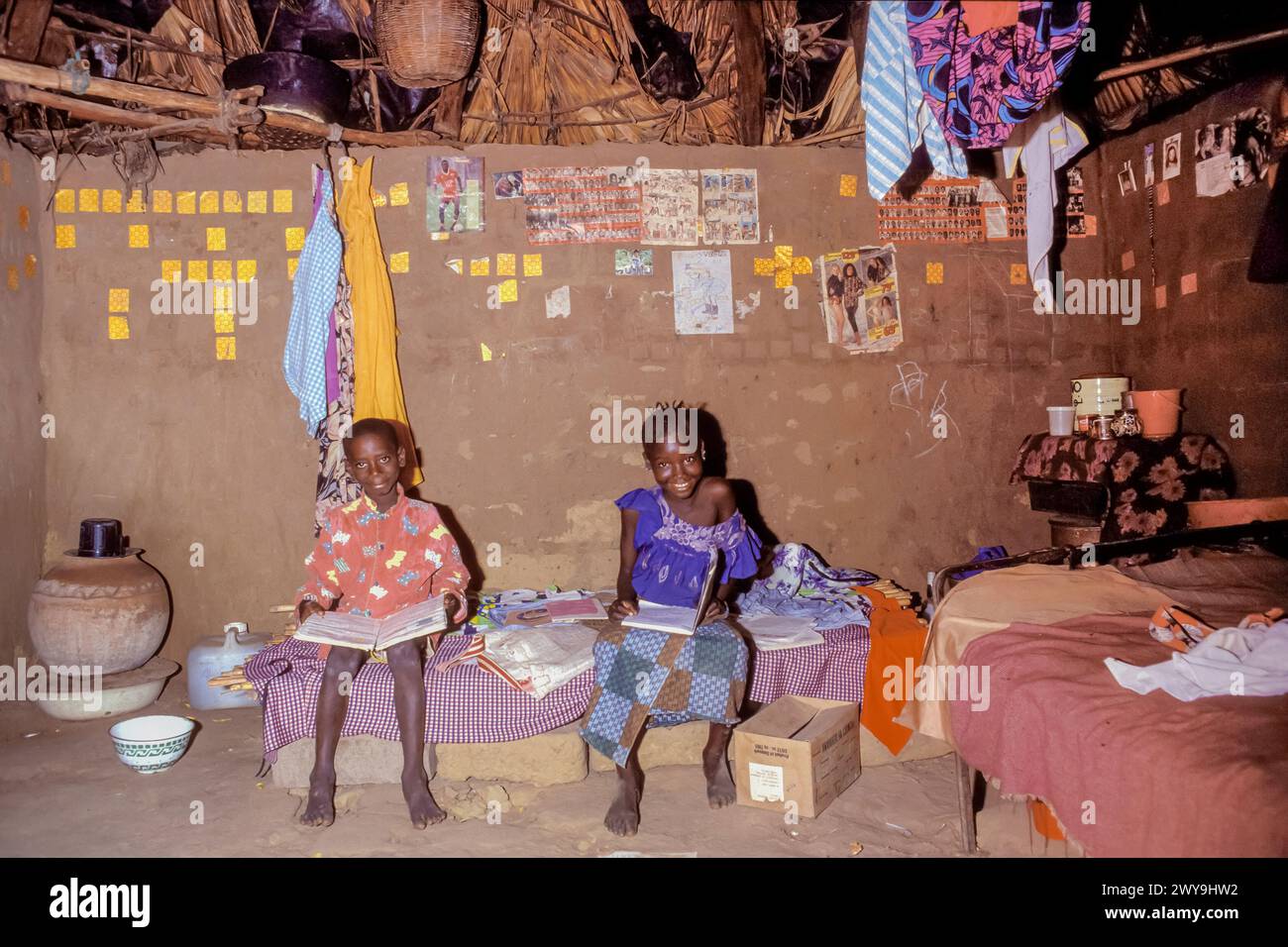 Senegal, Kaite; Children doing their school homework inside their ...