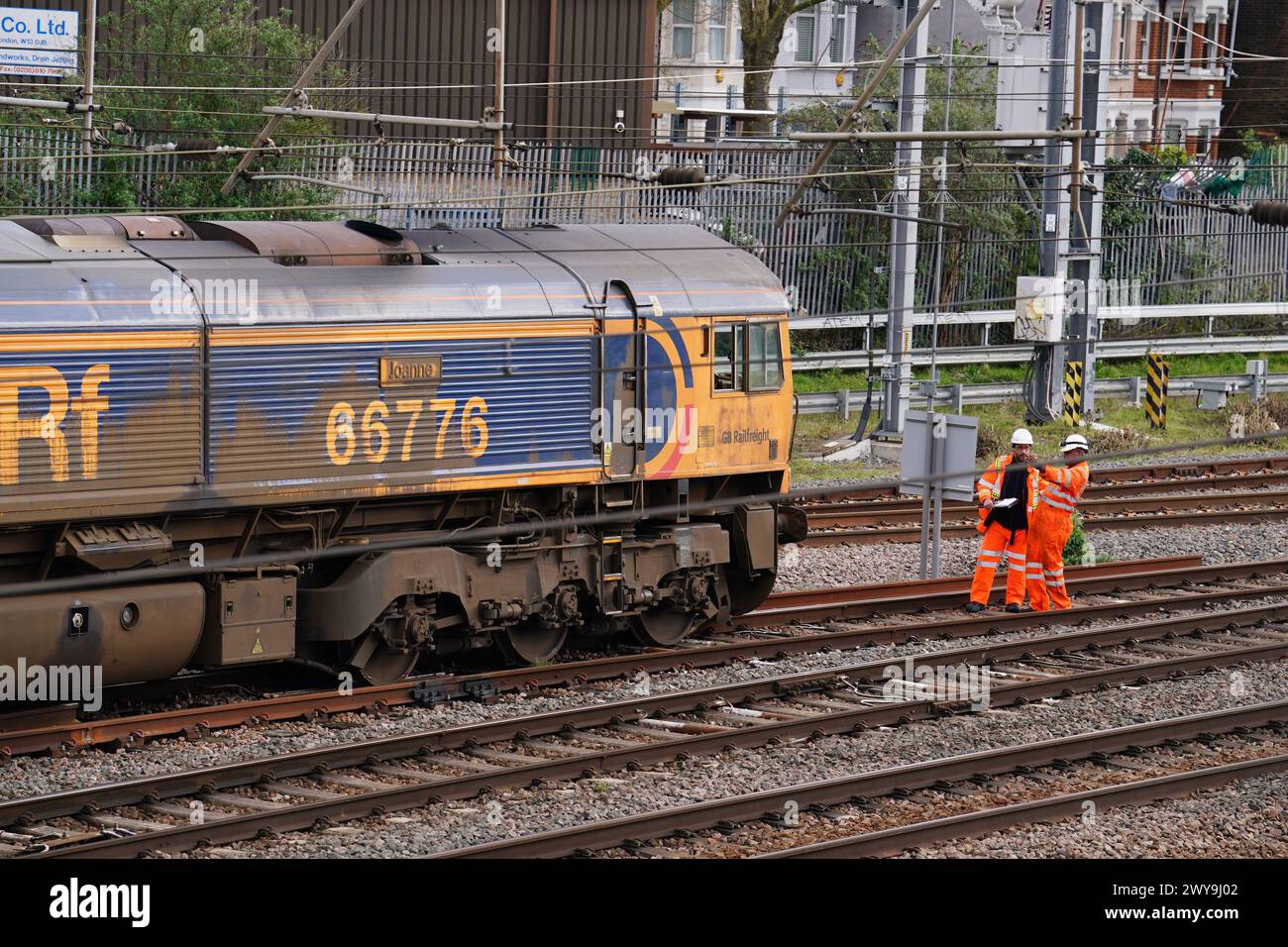 Railway workers at the scene of a freight train derailment in West ...
