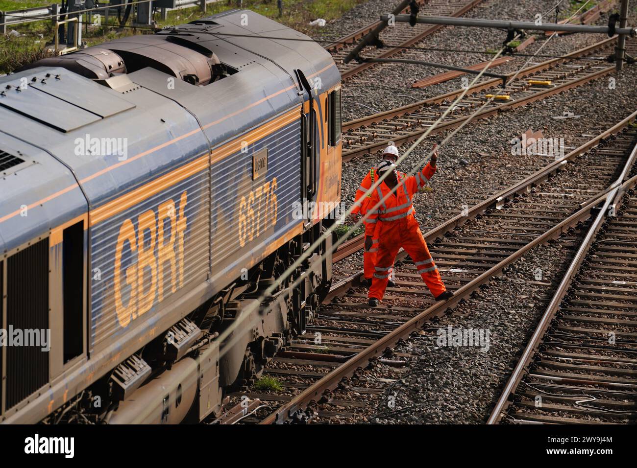 Railway workers at the scene of a freight train derailment in West ...