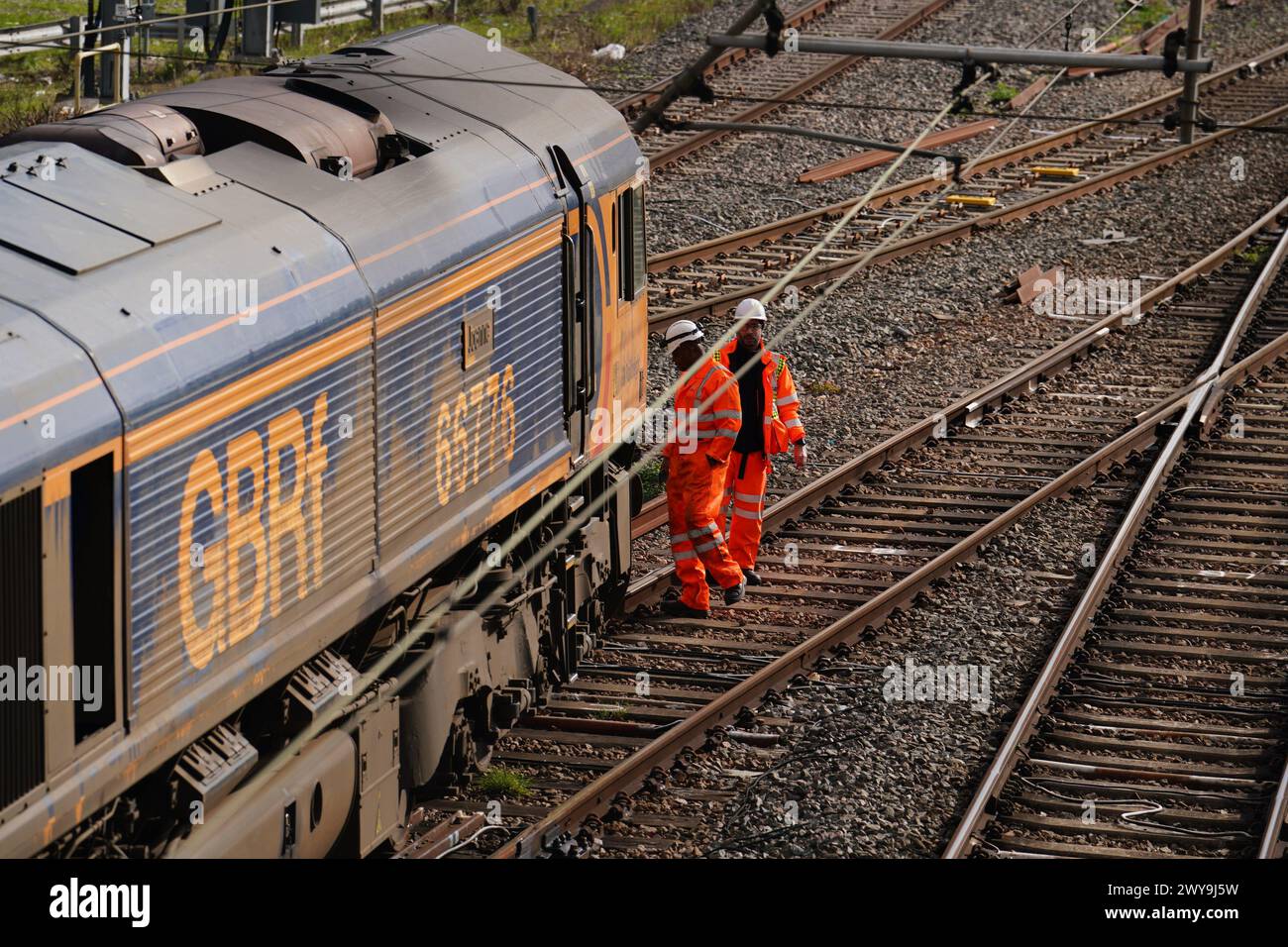 Railway workers at the scene of a freight train derailment in West ...