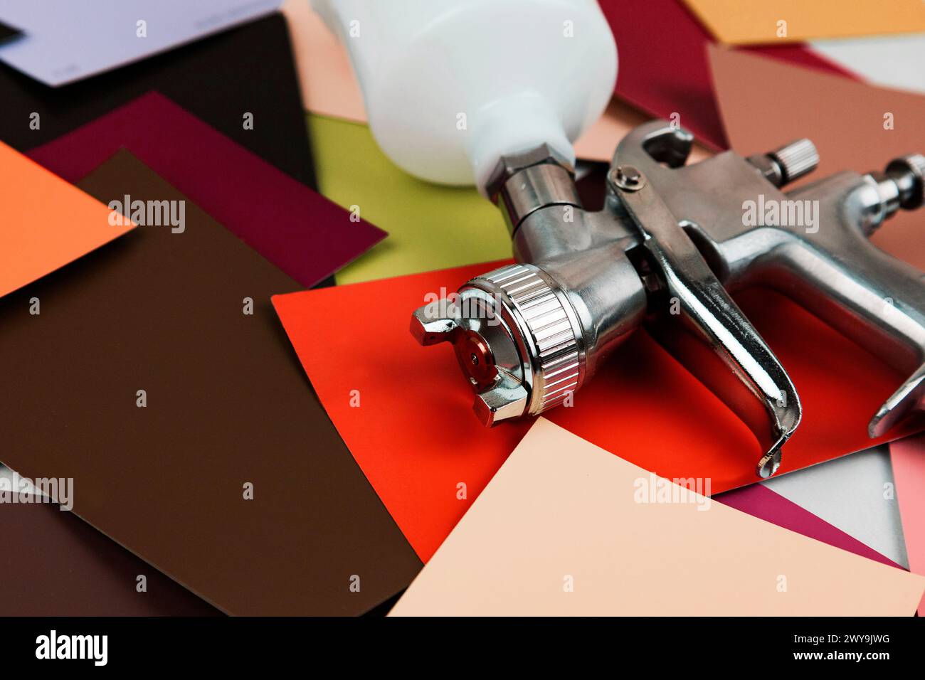 Paint spray gun at work at the workplace in the workshop. Paint Brush ...