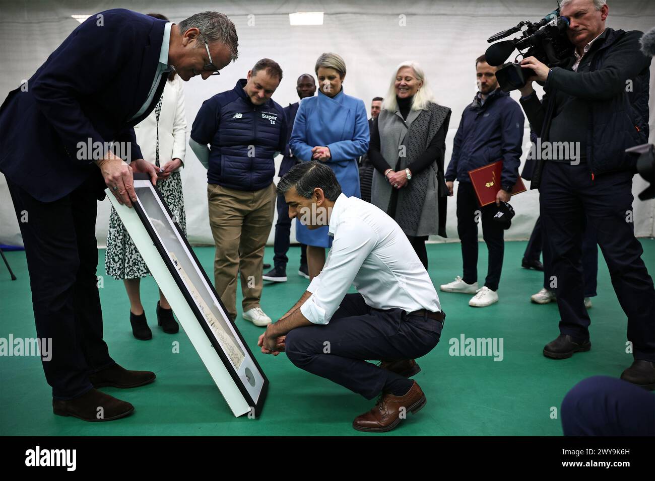 Prime Minister Rishi Sunak is presented with a signed cricket bat by ...