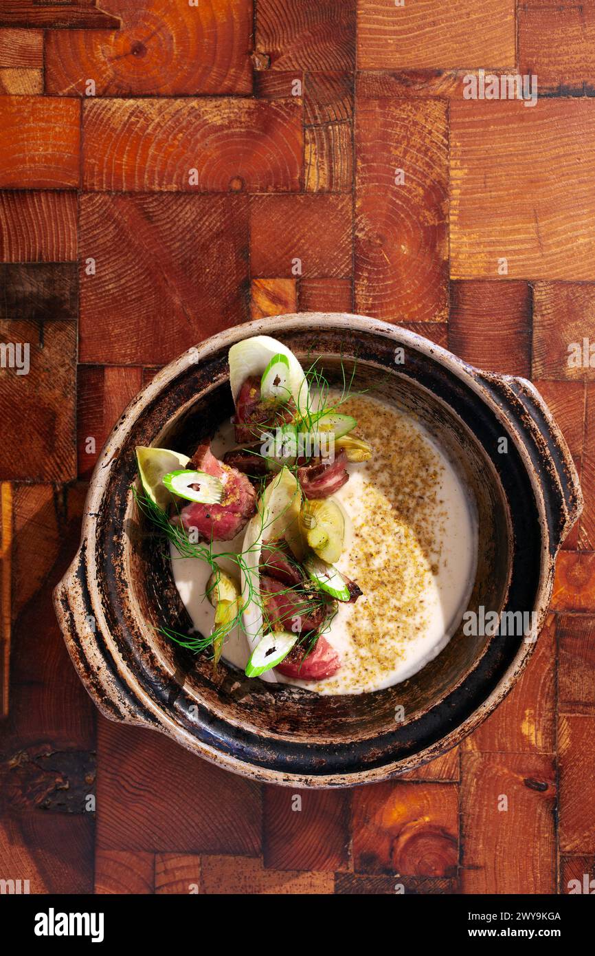 Overhead view of bowl of chowder on wood surface Stock Photo - Alamy