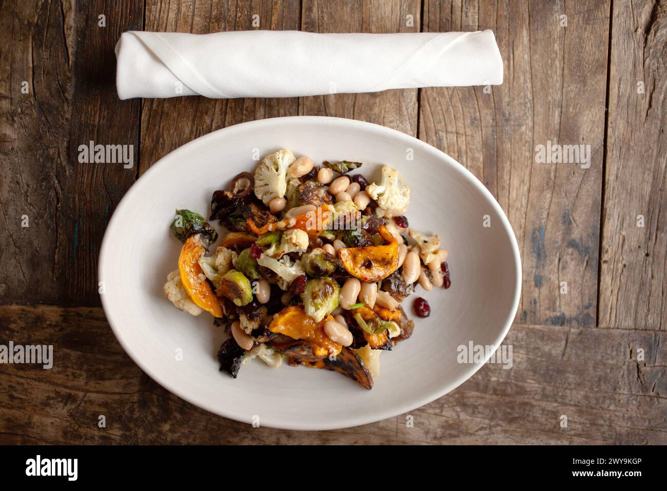 Overhead view of vegetable goulash on rustic wood table Stock Photo - Alamy