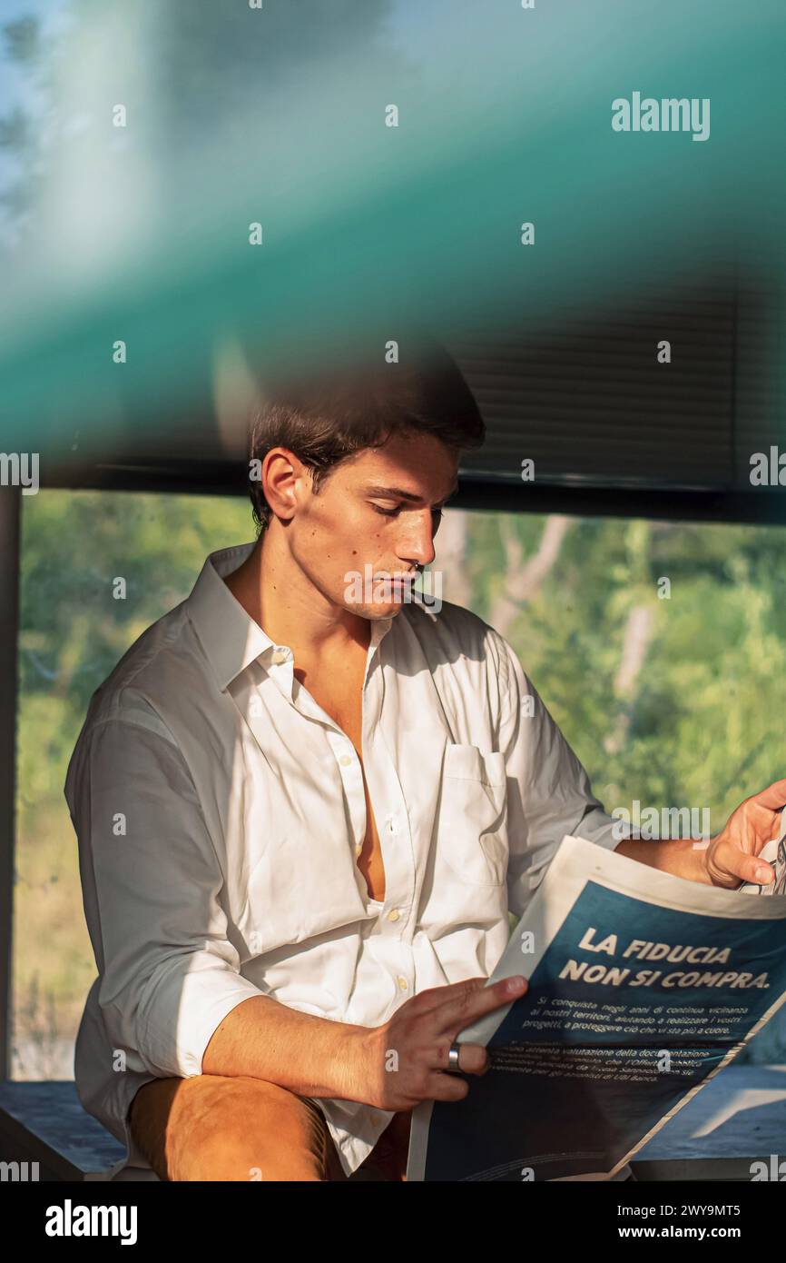 freelancer adult man reading a newspaper in an office room Stock Photo ...