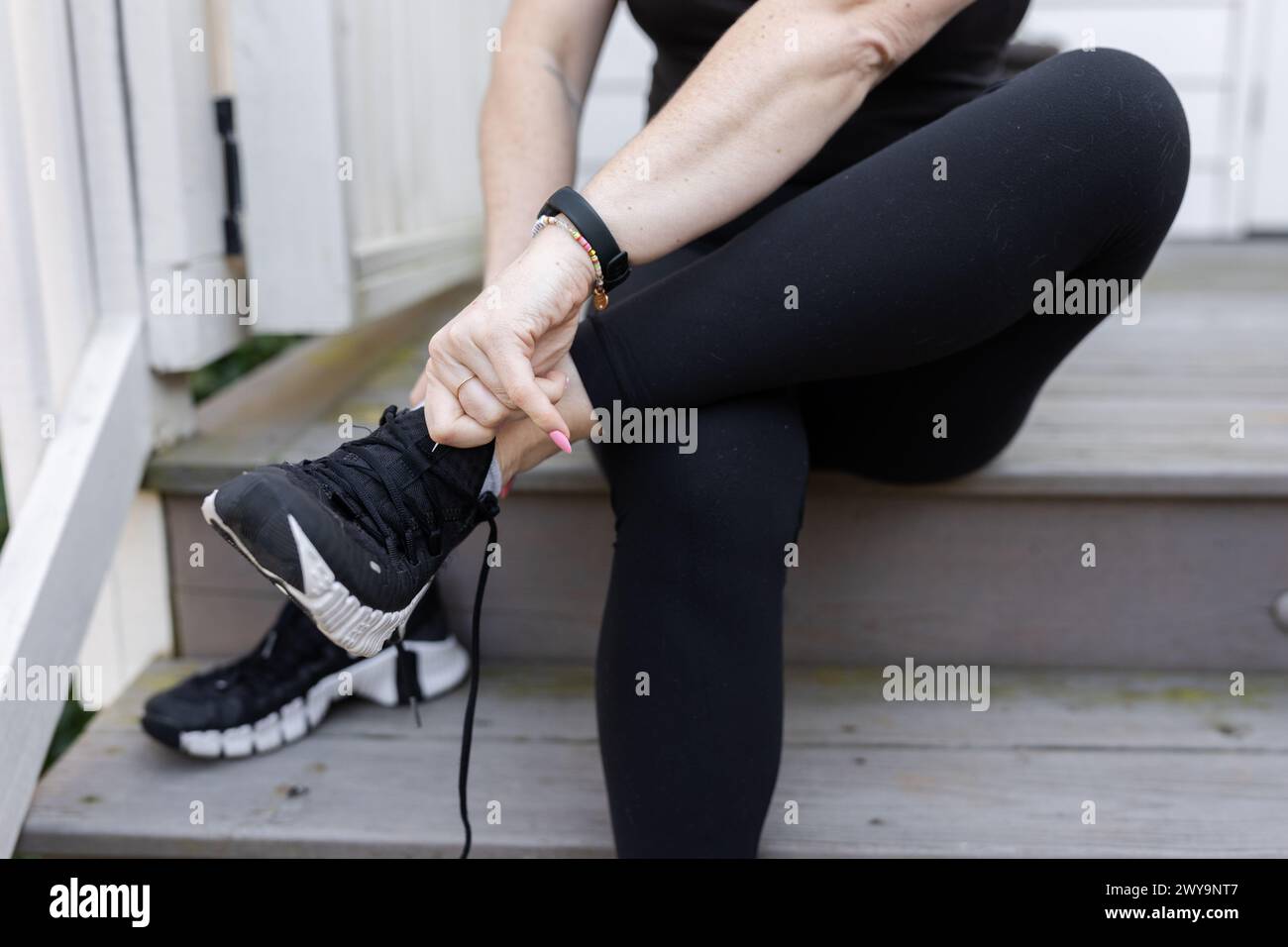 Woman tying shoelaces before hi-res stock photography and images - Alamy