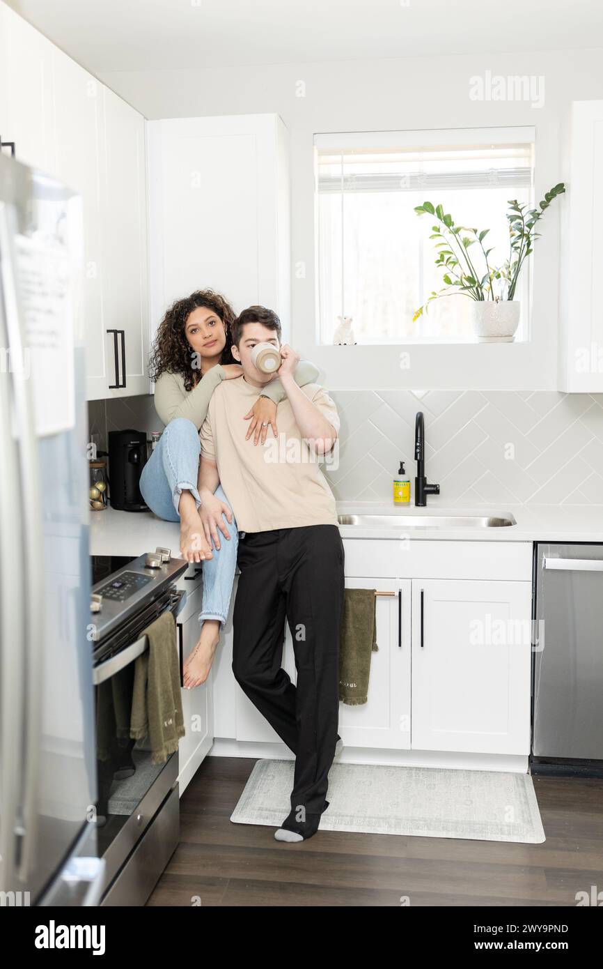 Intimate couple enjoys coffee in a sunny modern kitchen Stock Photo - Alamy