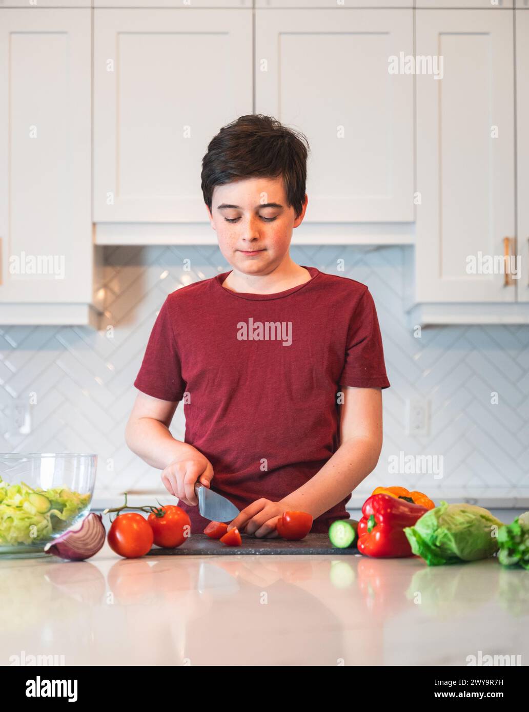 Teen boy cooking in the kitchen hi-res stock photography and images - Alamy