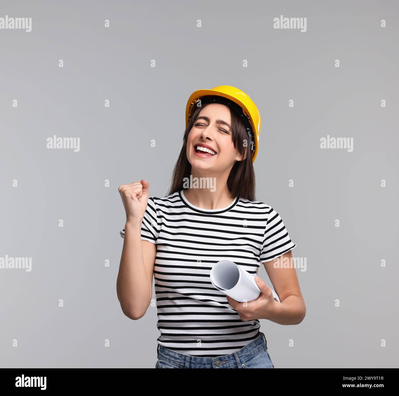 Architect with hard hat and draft on light grey background Stock Photo ...