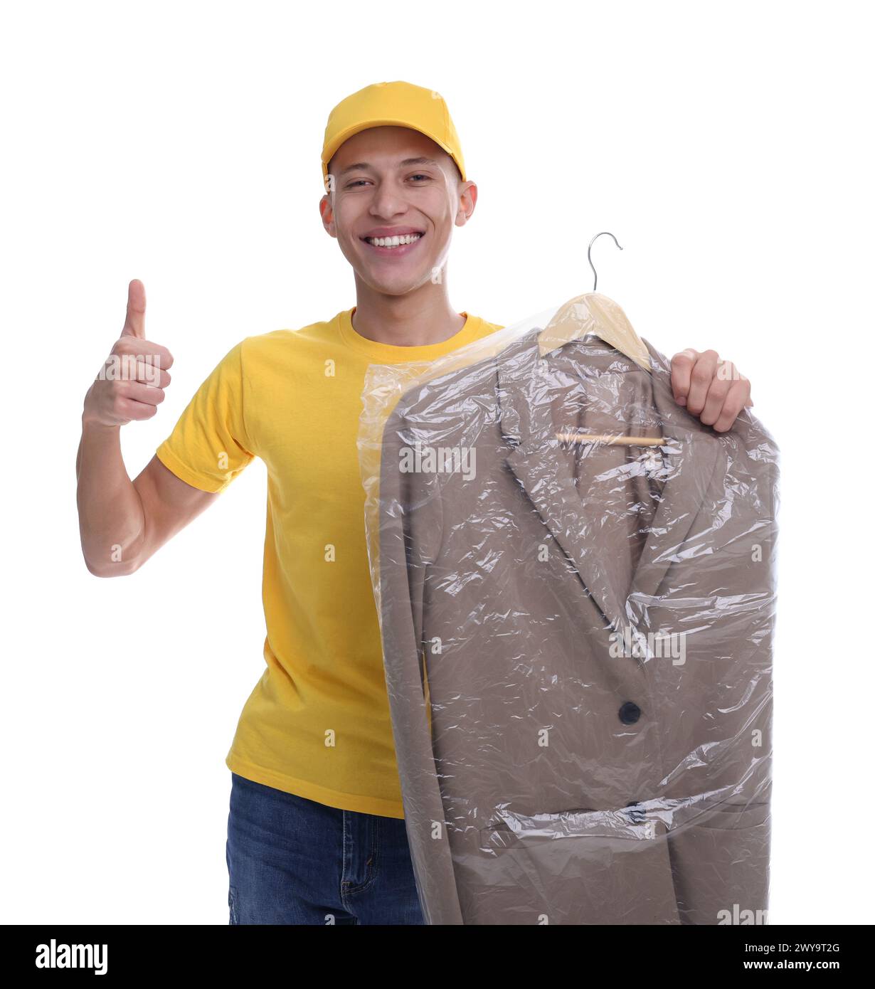 Dry-cleaning delivery. Happy courier holding jacket in plastic bag and ...