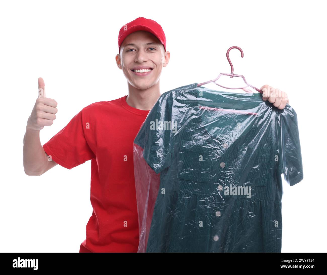 Dry-cleaning delivery. Happy courier holding dress in plastic bag and ...