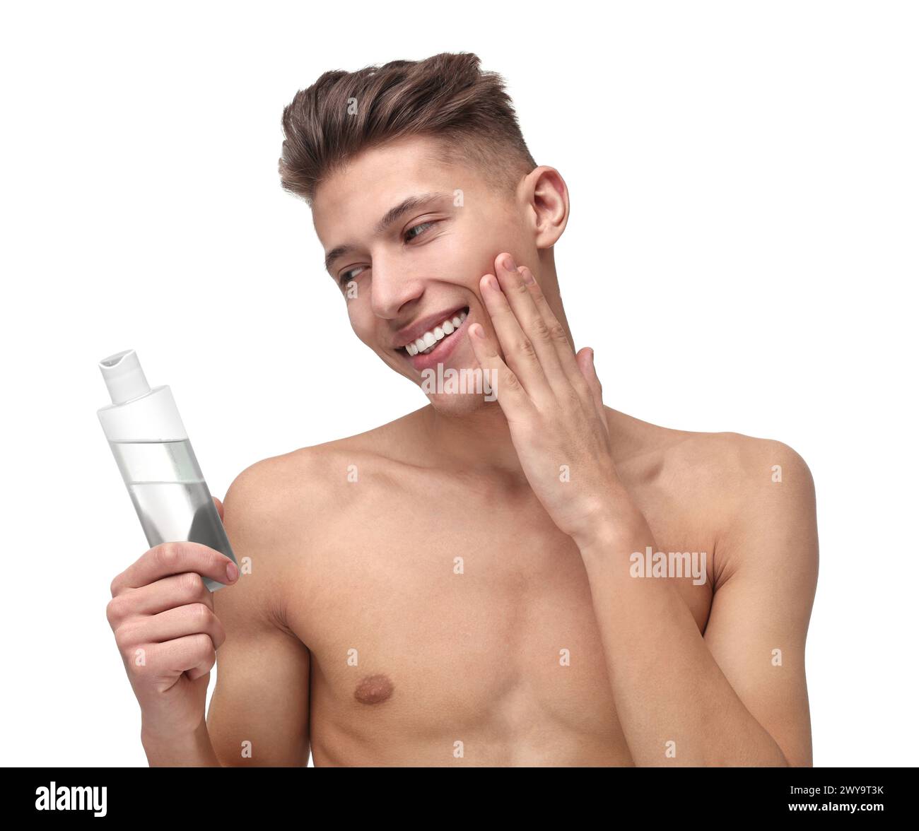Handsome man applying lotion onto his face on white background Stock Photo - Alamy