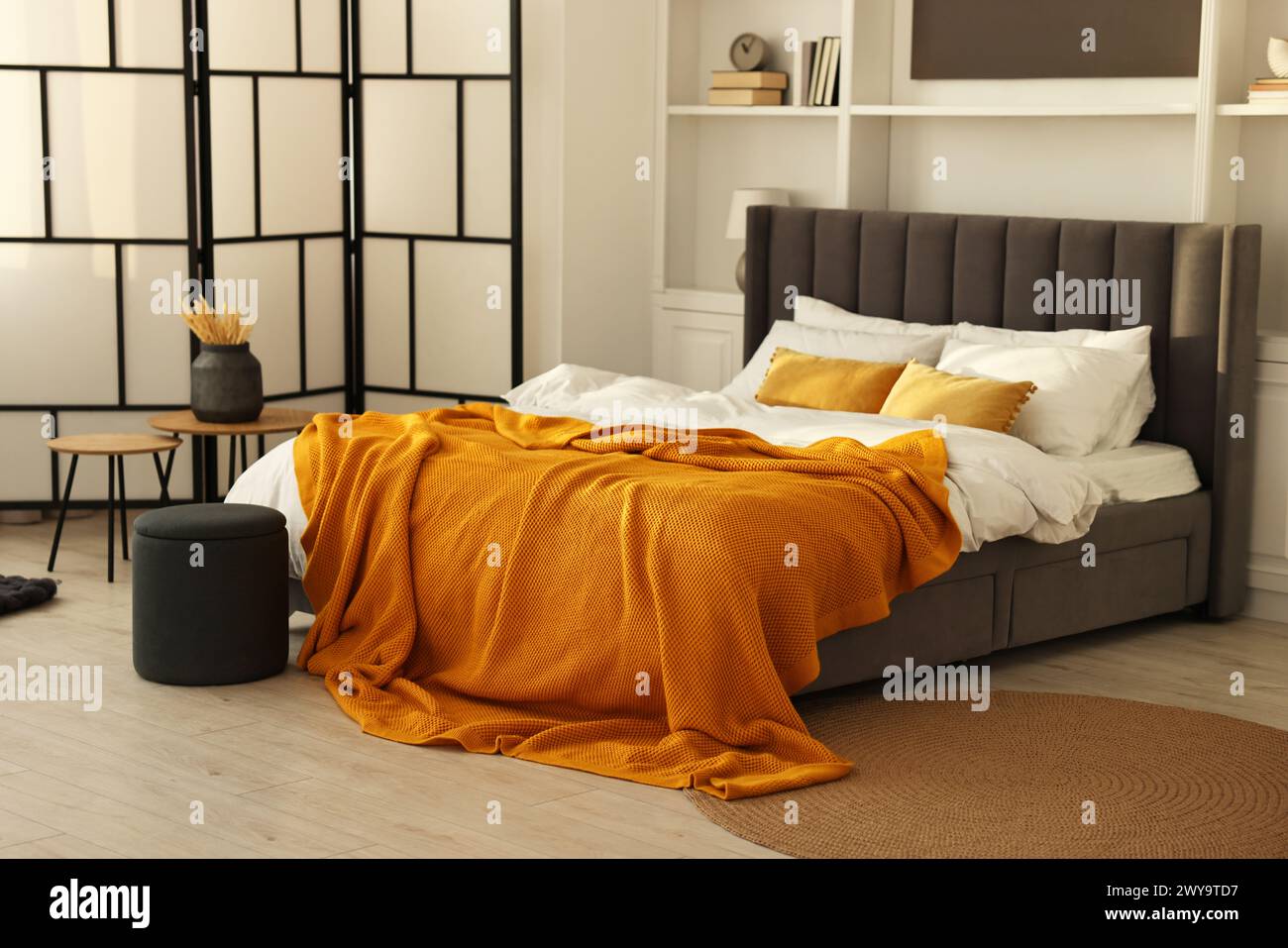 Bright plaid on bed in stylish bedroom. Interior design Stock Photo - Alamy