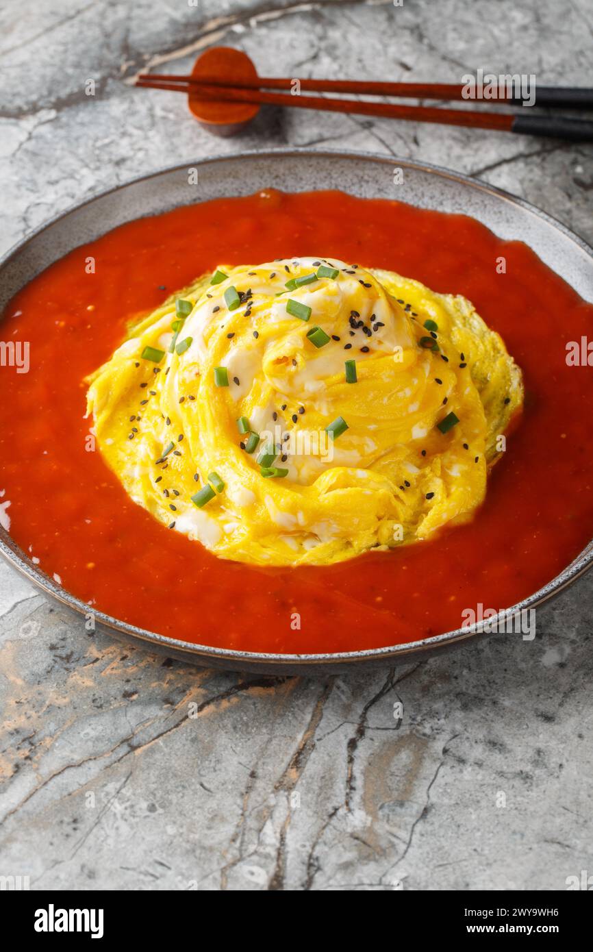 Korean tornado rice omelette and hot sauce closeup on the plate on the ...