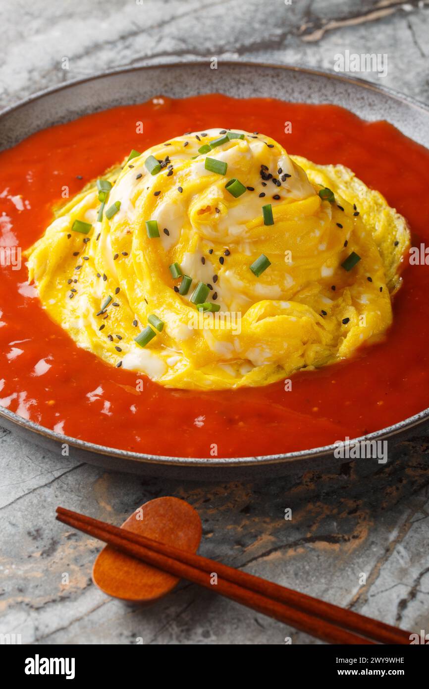 Korean tornado omelette over fried rice and hot sauce closeup on the ...