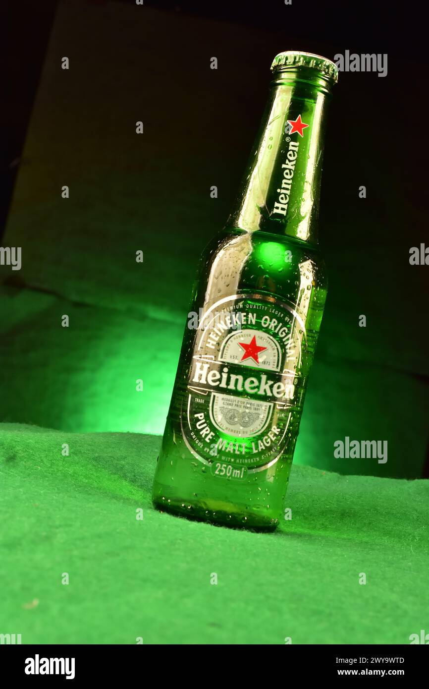 Bottle of Heineken beer on green background Stock Photo - Alamy
