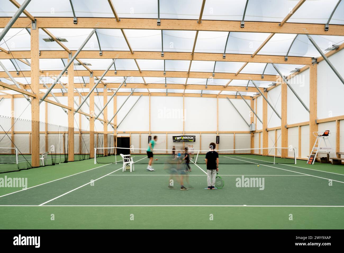 Tennis lesson in a sports hall. Children and tennis instructor Stock ...