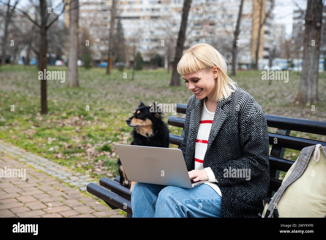 Young successful hipster businesswoman generation Z sitting on park ...