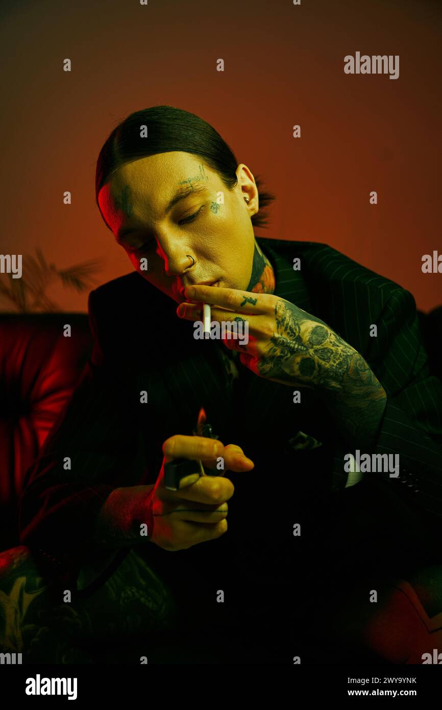 A man seated on a couch, smoking a cigarette Stock Photo - Alamy