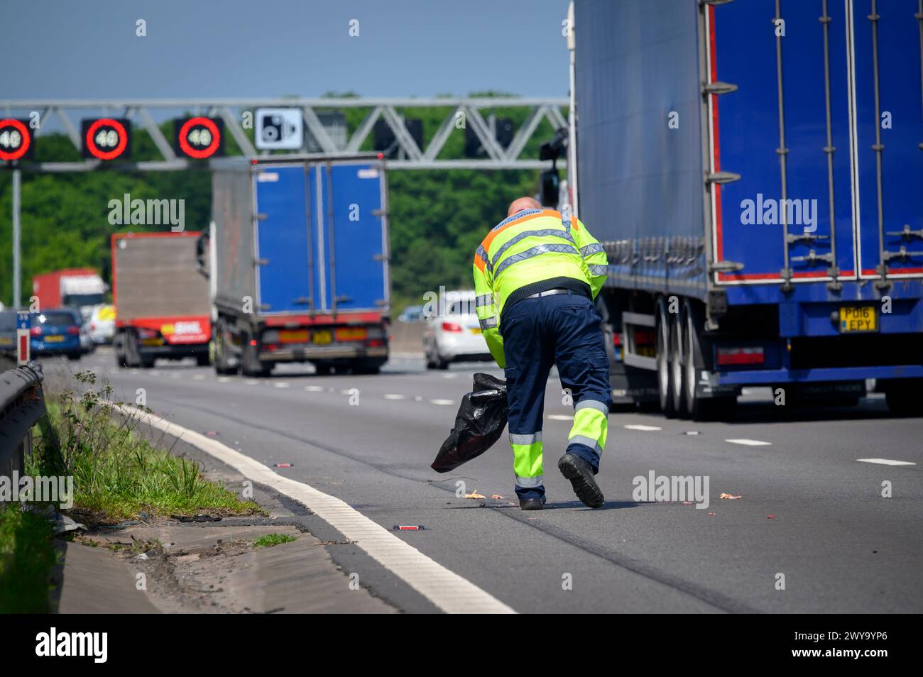 National Highways traffic officer clearing a lane after an incident on ...