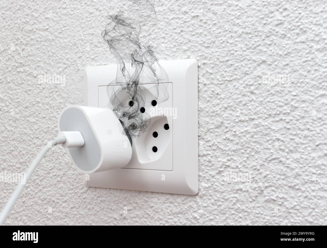 Smoke on electric wire plug phone charger in indoor, electric short ...